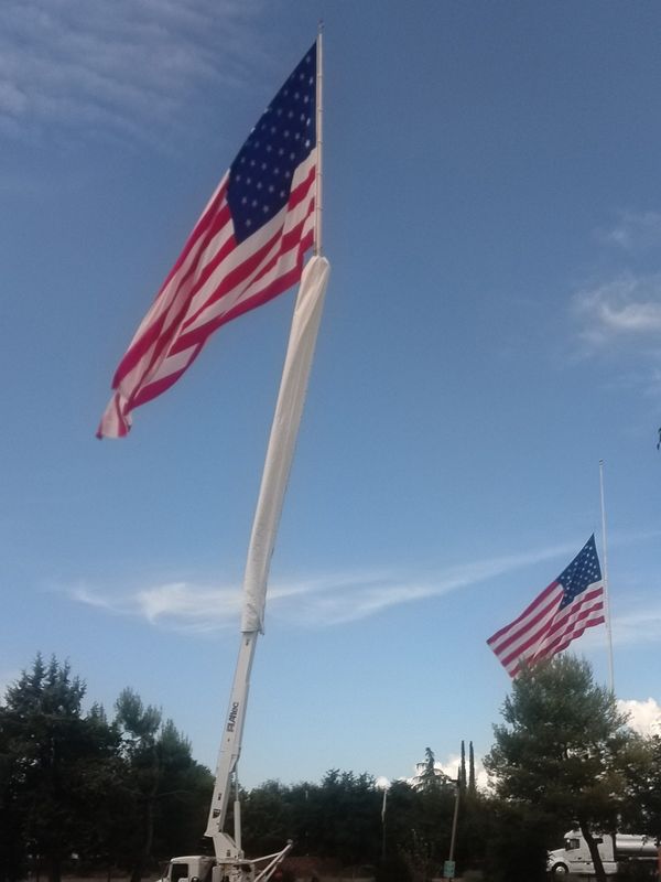 Why are 2 giant American flags flying over Interstate 5 in Redding?