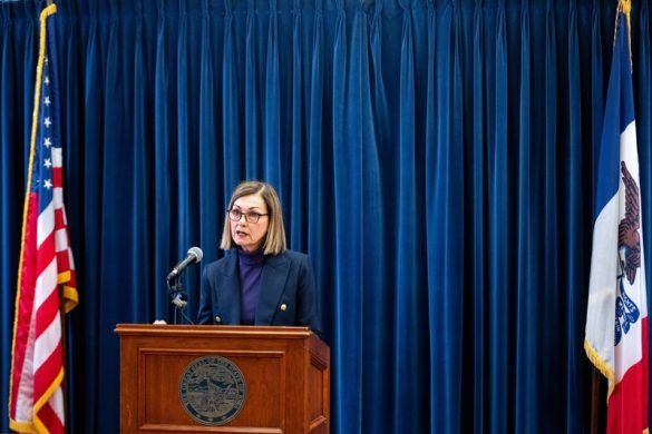 Kim Reynolds signs law hiking tax on private insurers to fund Medicaid