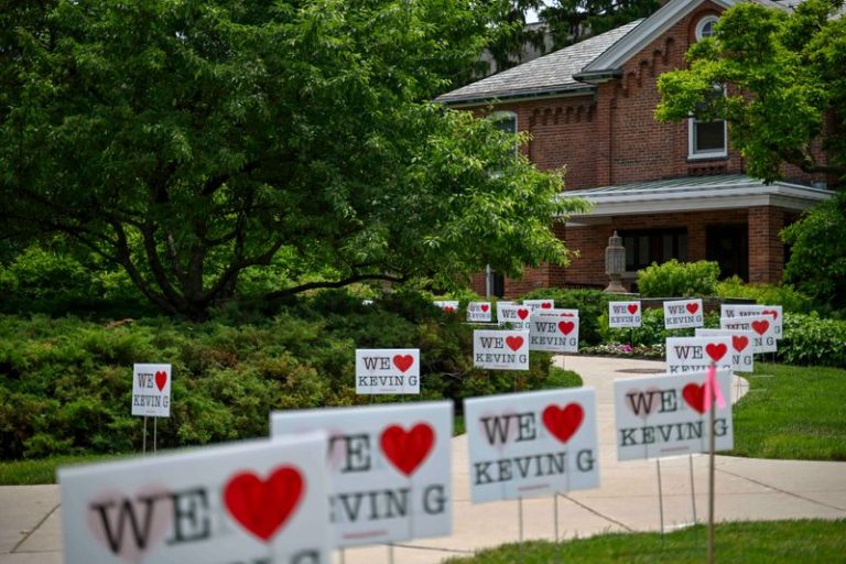 Signs support outgoing MSU President Guskiewicz appear on campus