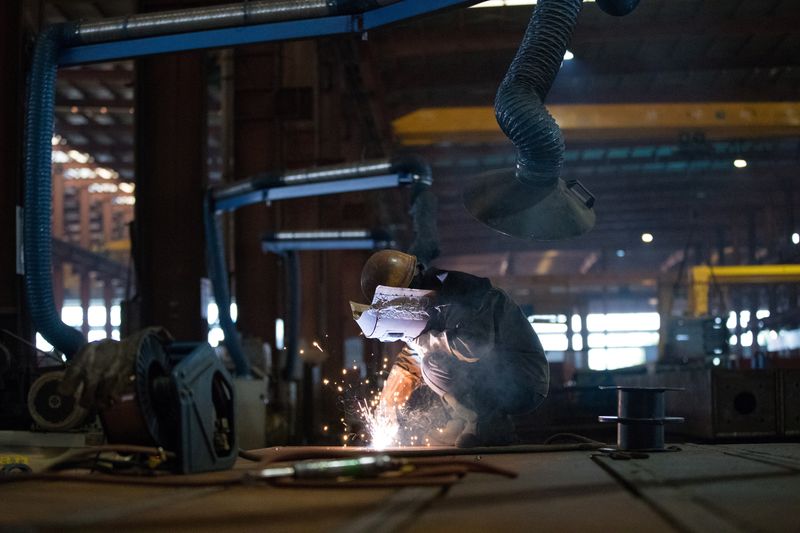 China's factory activity snaps record slump on festive stockpiling